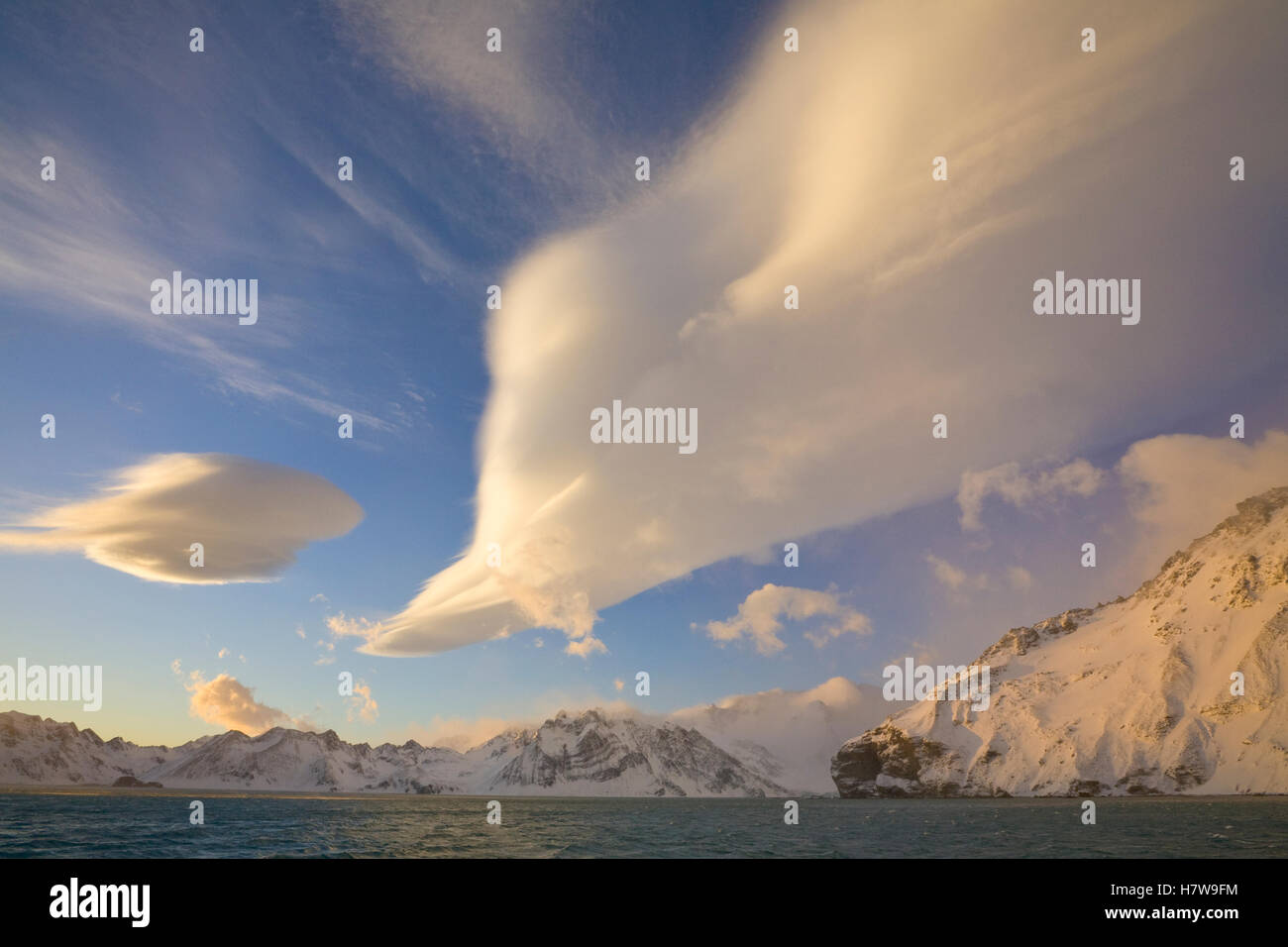 Lenticular clouds lit by rising sun, Moltke Harbor, South Georgia ...