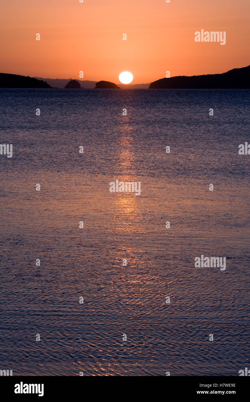 Sunset over water, Coromandel Peninsula, New Zealand Stock Photo - Alamy