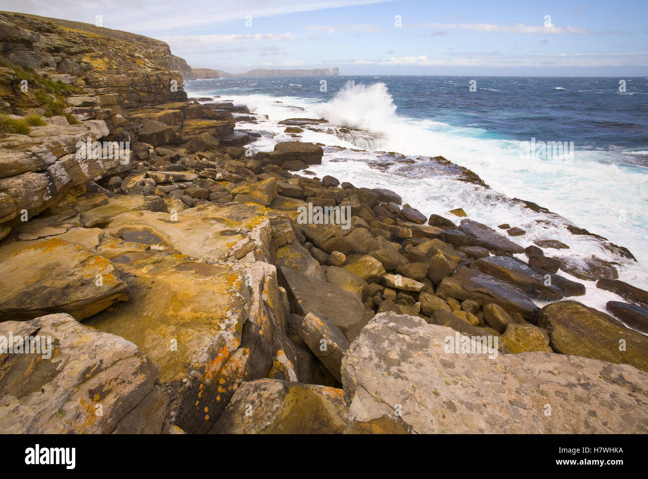 Rocky seashore, steep cliffs with colorful lichens, Beaver Island ...