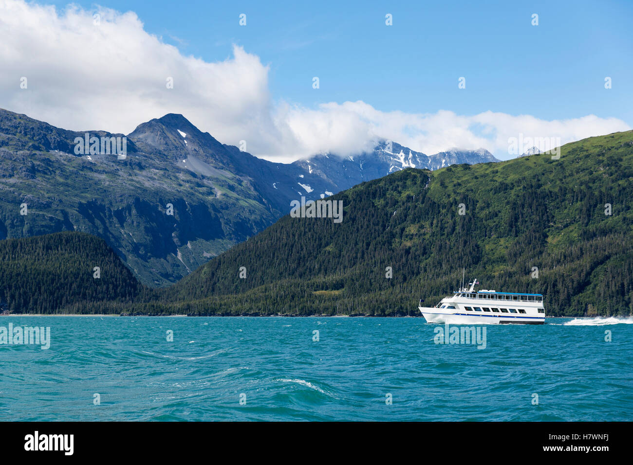 A small double deck passenger boat motors through the Passage Canal on ...