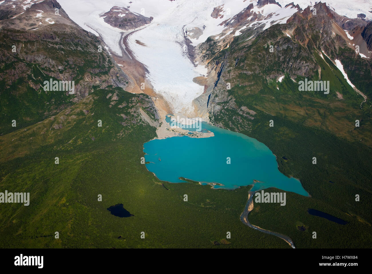 Aerial of glacier showing medial and end moraines with glacial lake ...