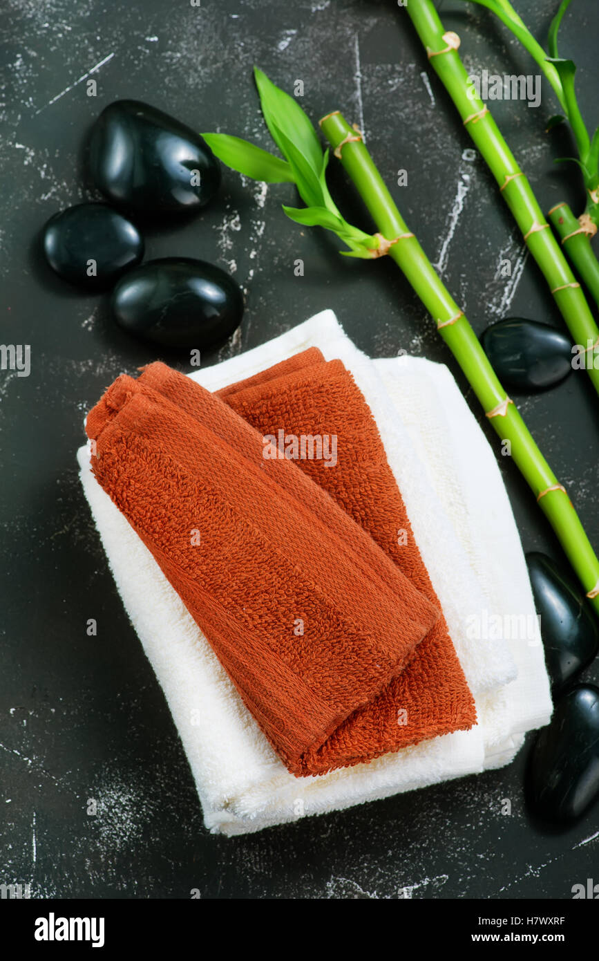 clear towels, black stones and bamboo on a table Stock Photo - Alamy