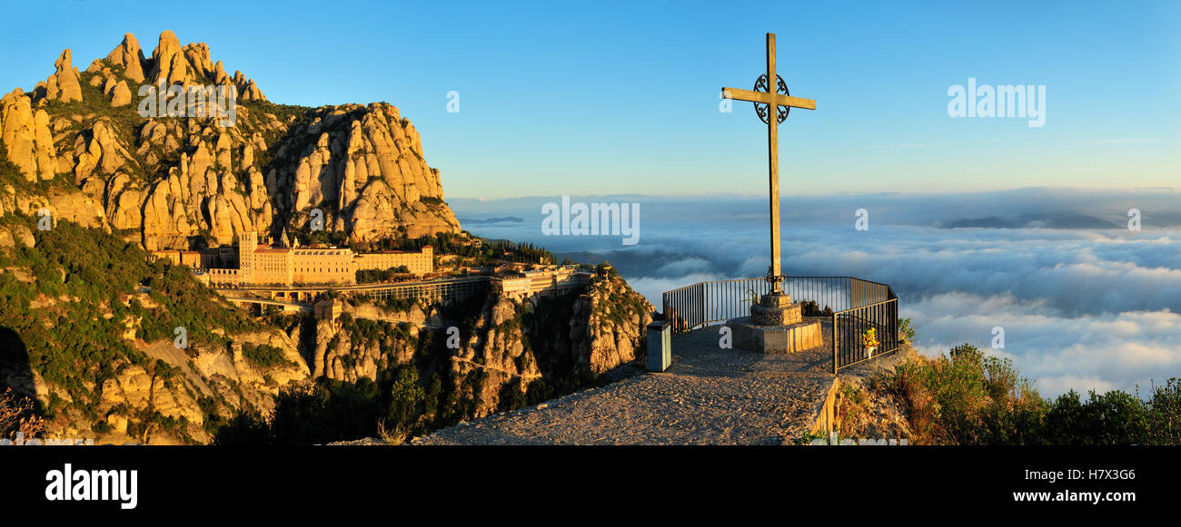 Cross on overlook with Montserrat Basilica in the background ...