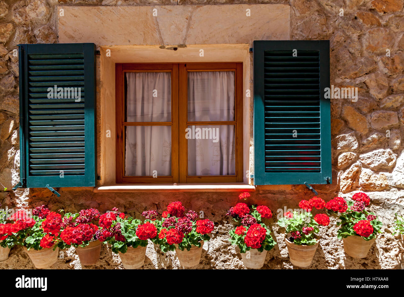 Window with open shutters and blooming flower pots,Window in flowers ...