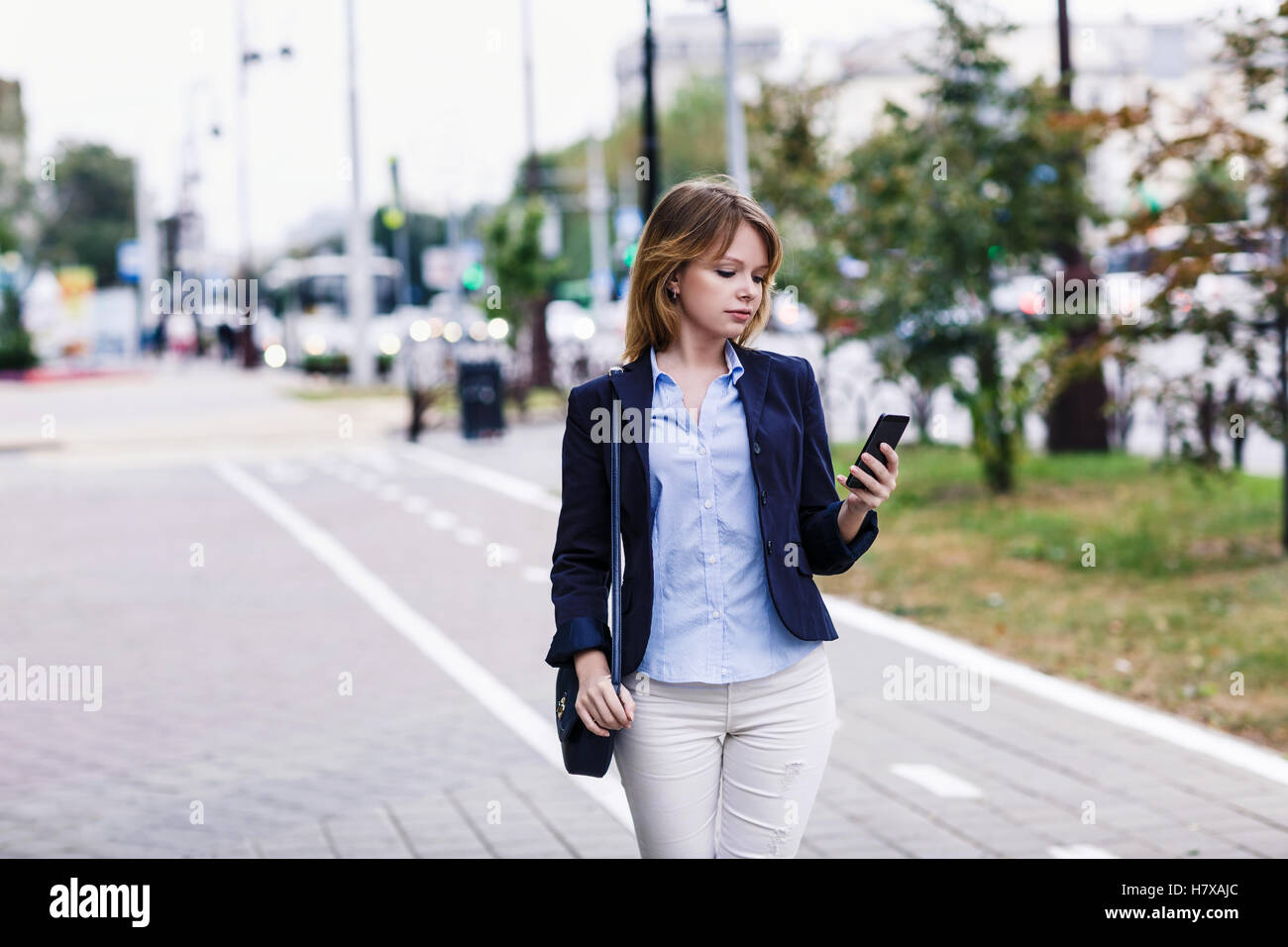 Young woman using mobile phone Stock Photo - Alamy
