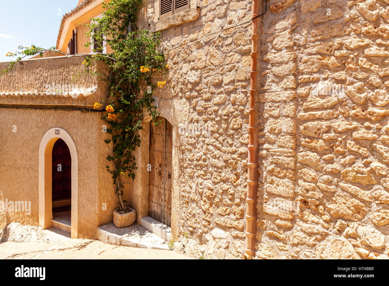 Southern street with old traditional houses and a flowerpot near ...
