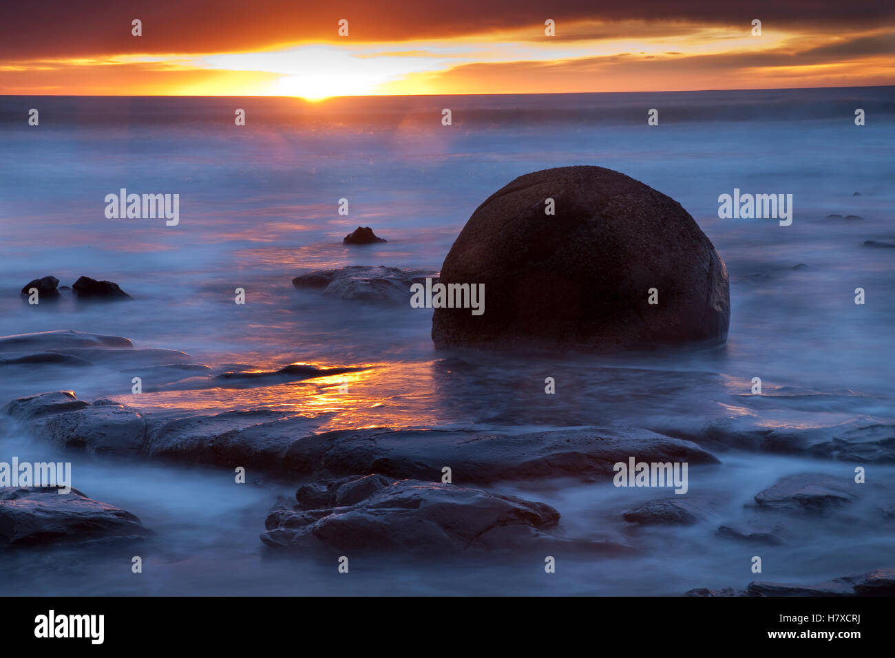 Round boulder in the surf, Moeraki Beach, South Island, New Zealand ...