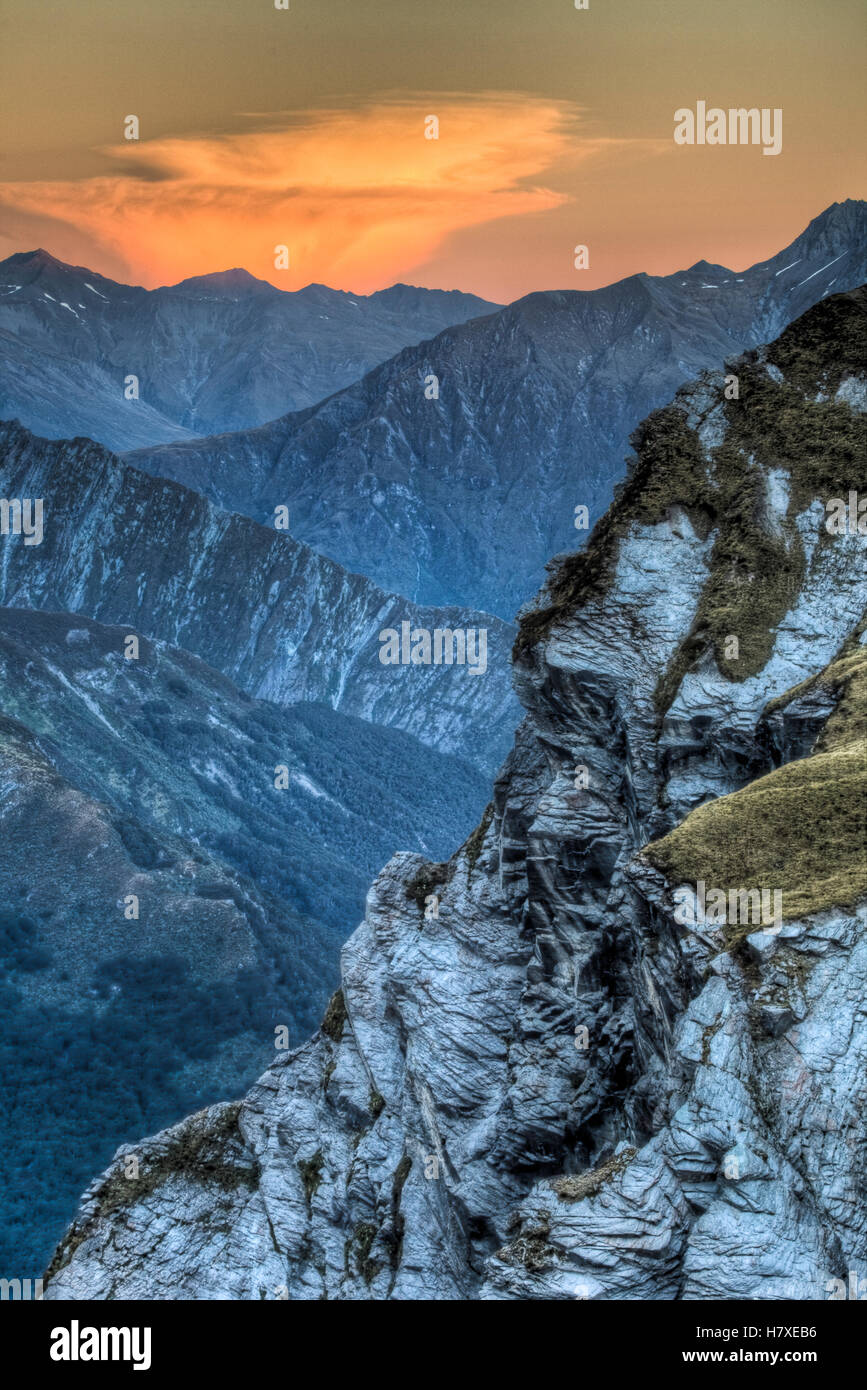 Anvil shaped cloud at sunset above Matukituki Valley, from Cascade ...