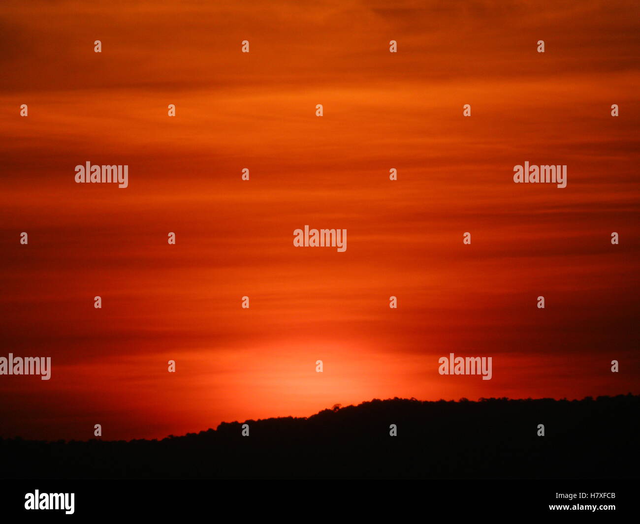 Breathtaking red color gradation of sunset sky over the hills, Northern ...