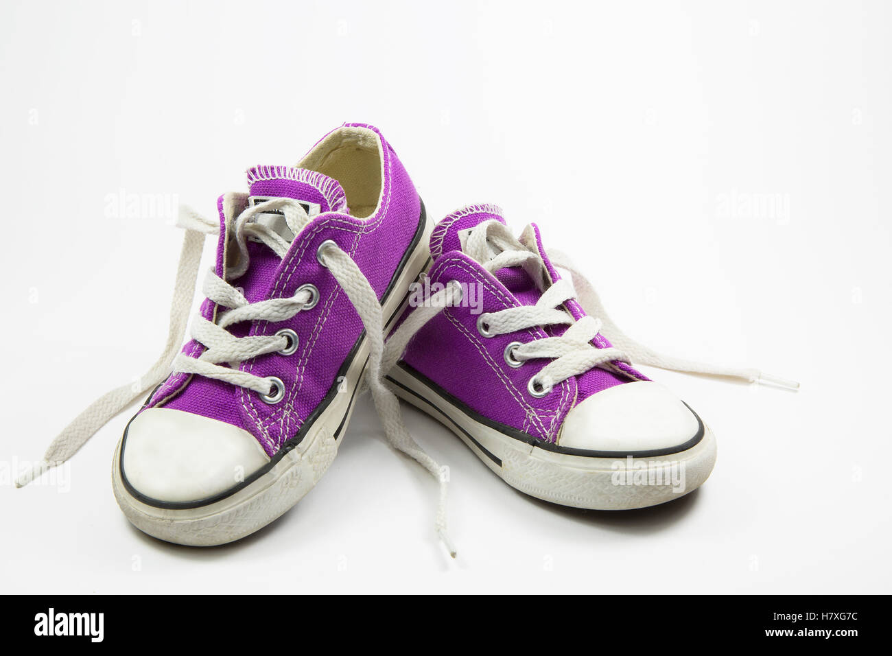 portrait of a little girl sneakers shoes Stock Photo - Alamy