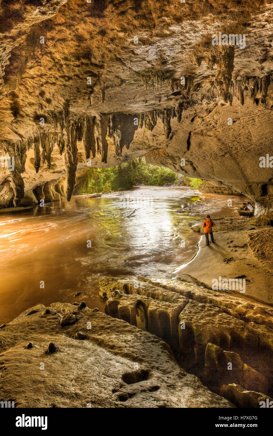 Moria Gate Arch with limestone stalagtites on roof and tourist watching ...