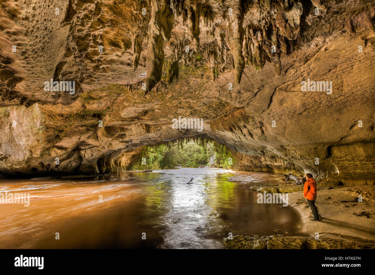 Moria Gate Arch with limestone stalagtites on roof and tourist watching ...
