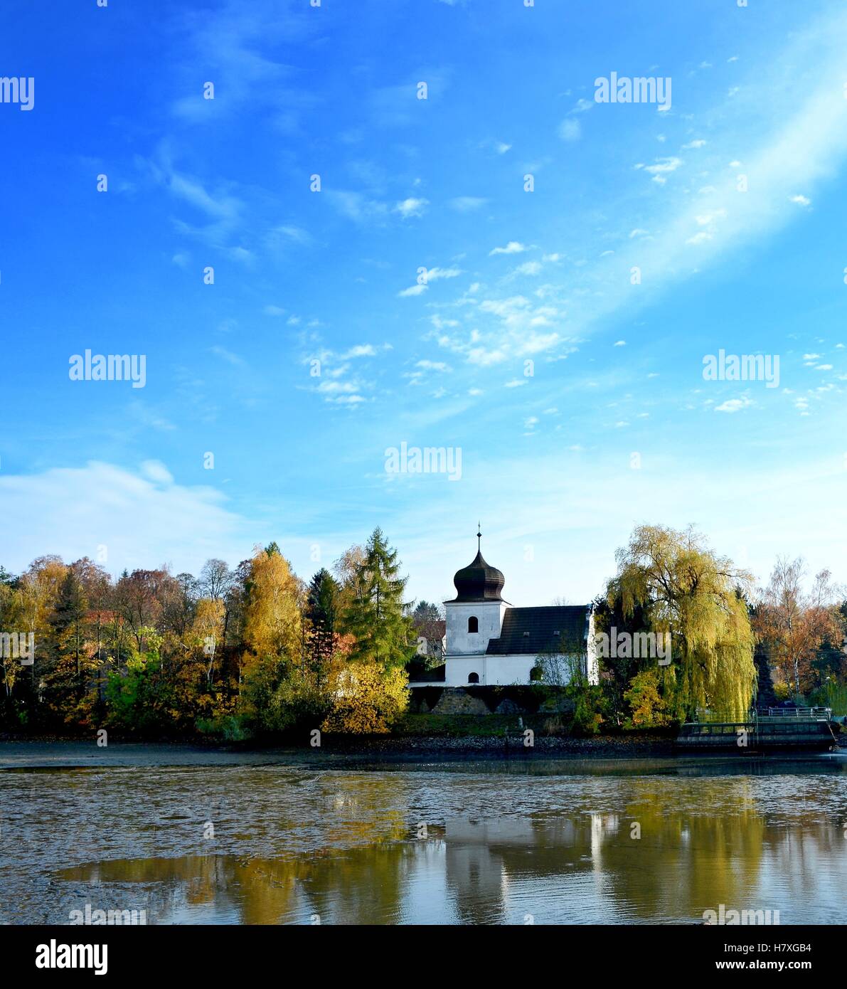 The church at pond with reflection in water and blue sky Stock Photo ...