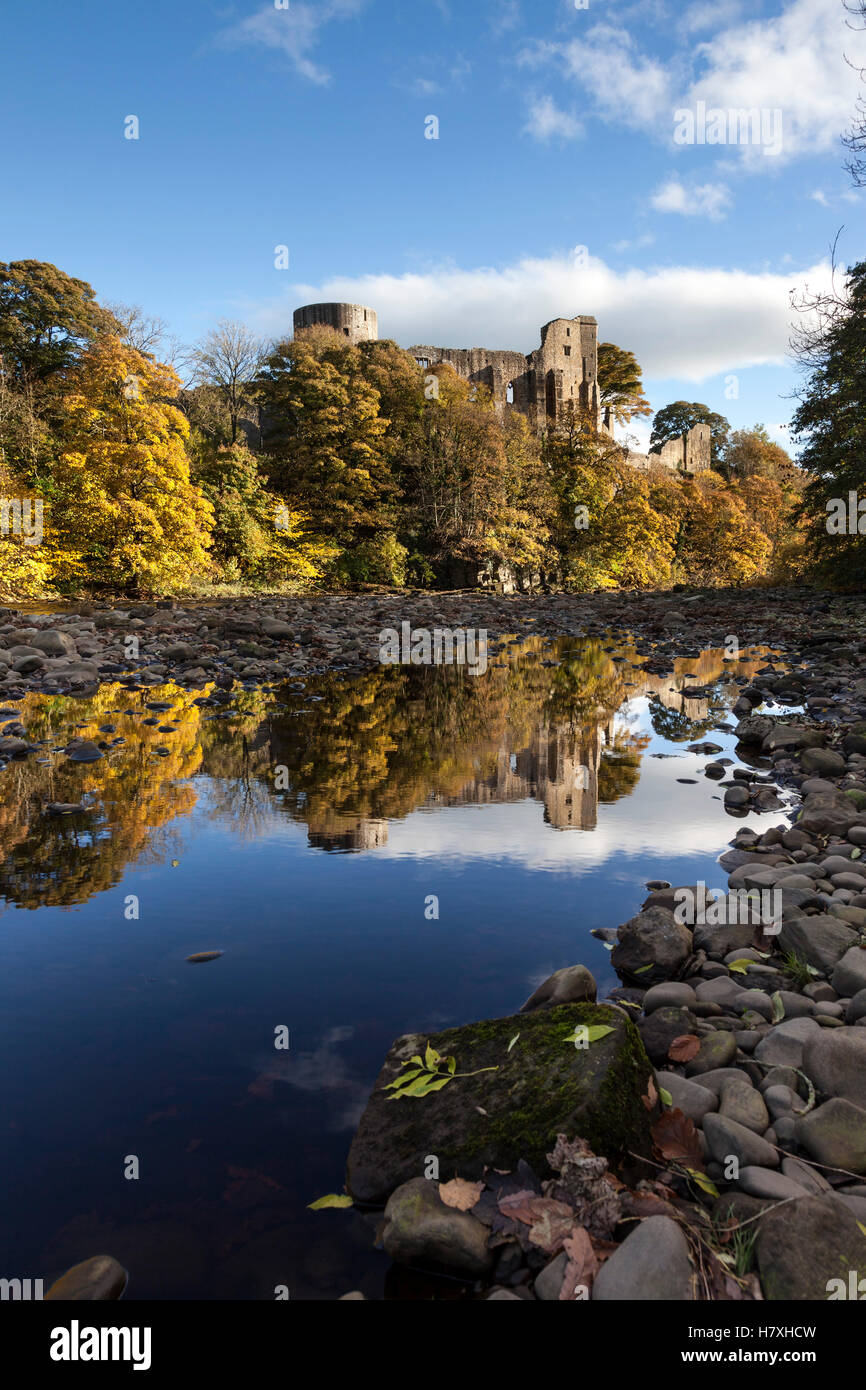 The medieval ruins of Barnard Castle reflected in the River Tees in ...