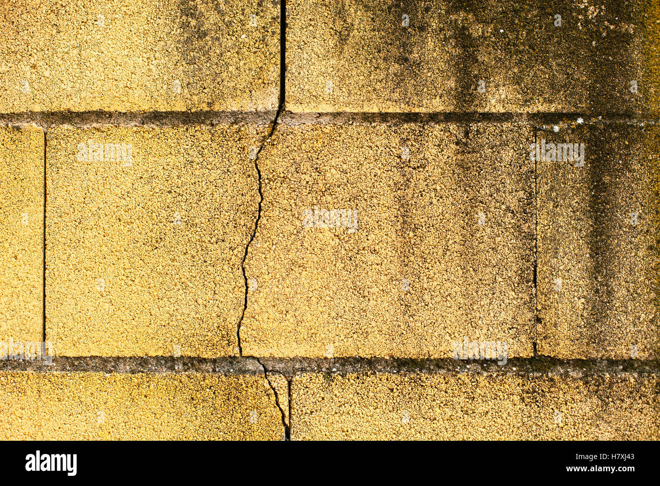 Surface of a yellow wall cracked by the passage of time Stock Photo - Alamy