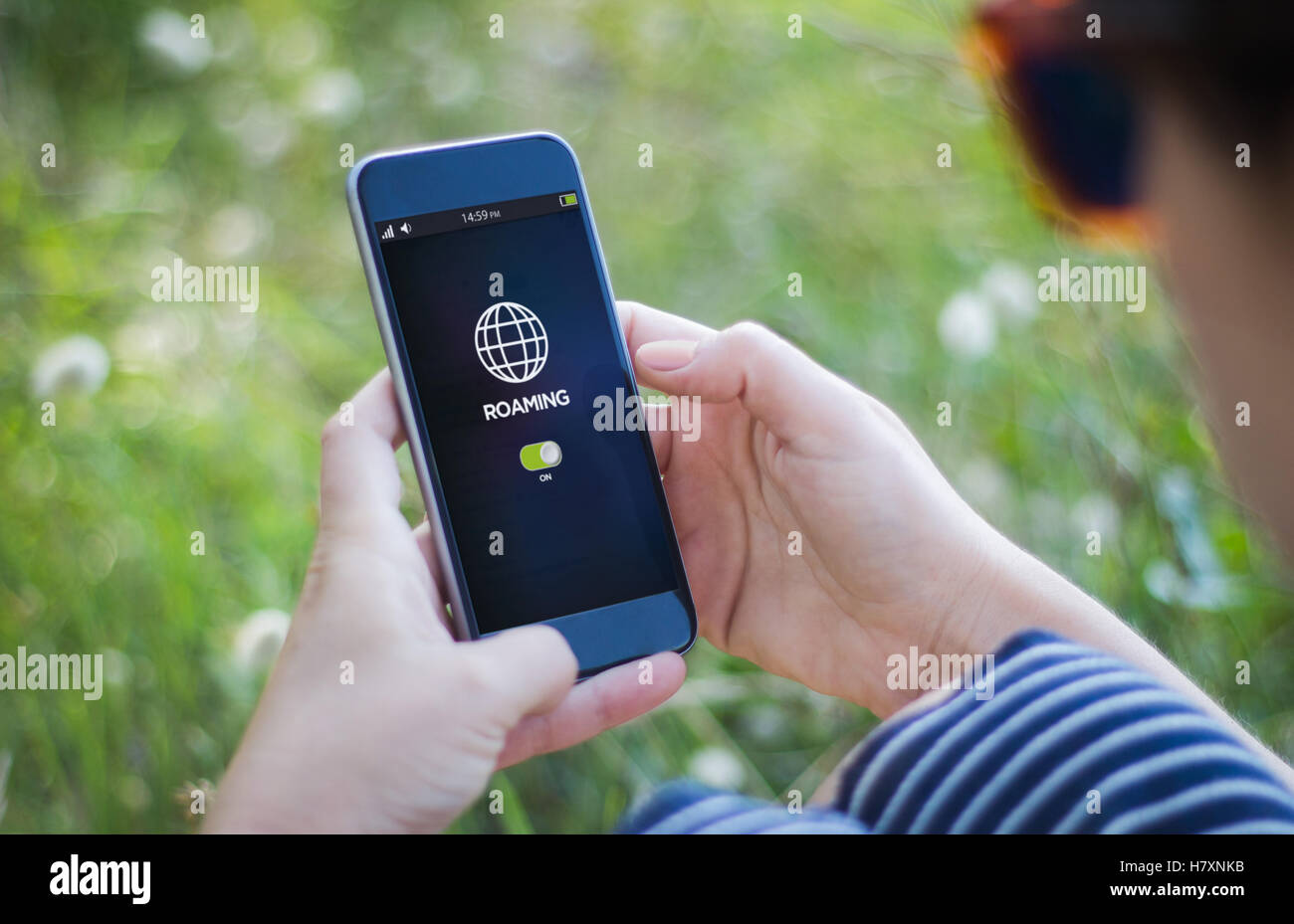 woman holding her smartphone and checking roaming. All screen graphics ...