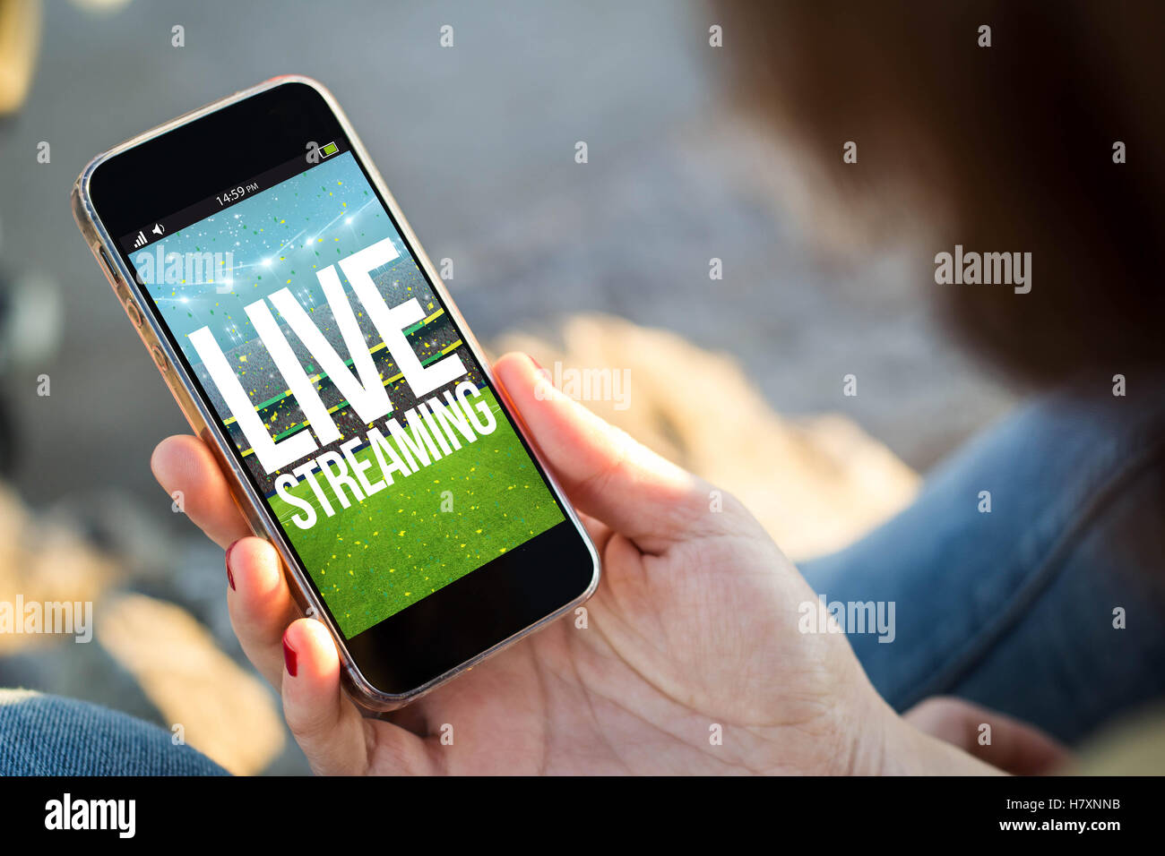close-up view of young woman with live streaming event on her mobile ...