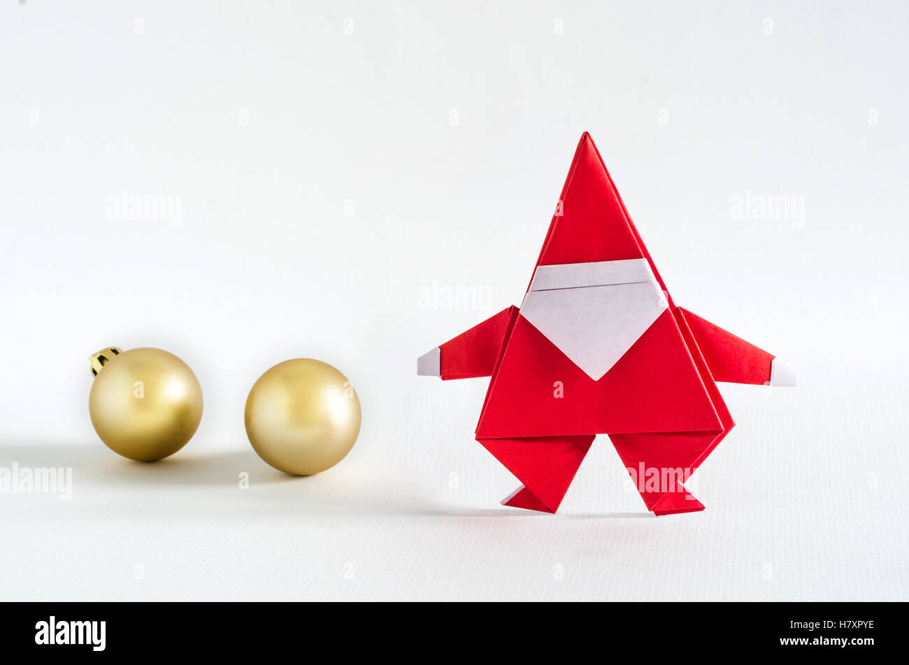 Santa Claus paper craft and golden ball on white background. Paper ...