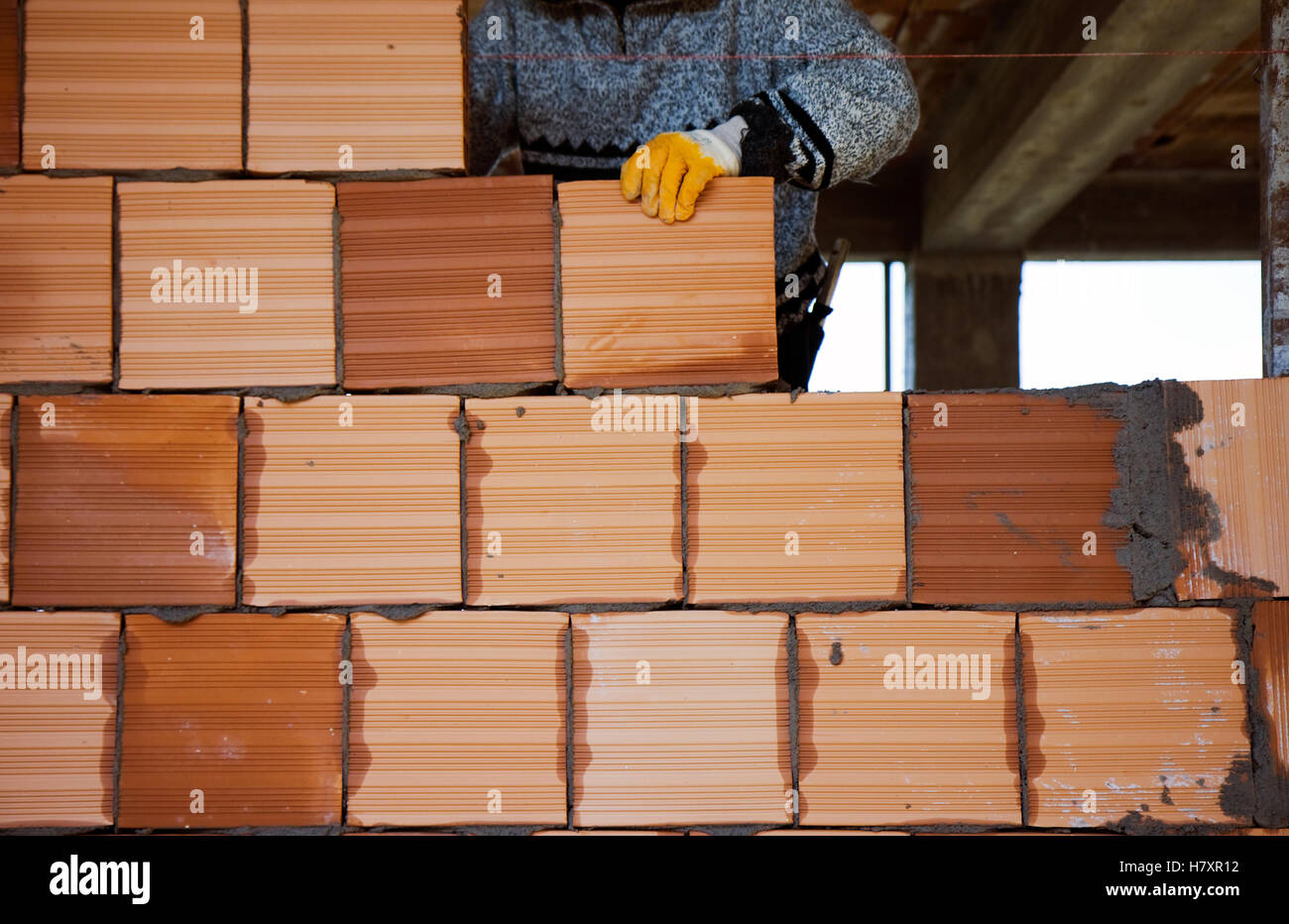 bricklayer working in a building site Stock Photo - Alamy