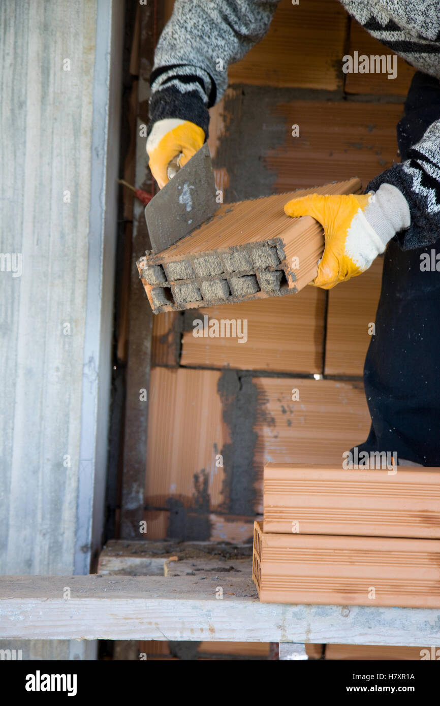 bricklayer working in a building site Stock Photo - Alamy