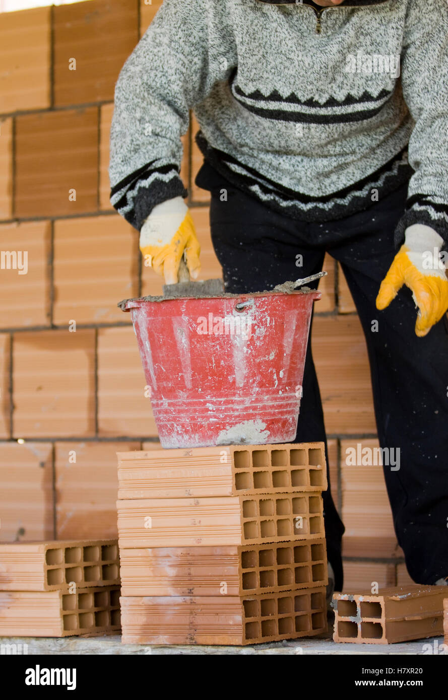 bricklayer working in a building site Stock Photo - Alamy