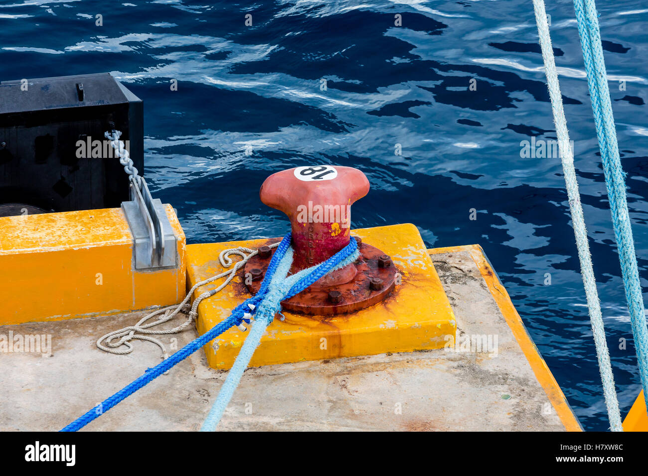 Blue Ropes on a Red Bollard in a Harbor Stock Photo - Alamy