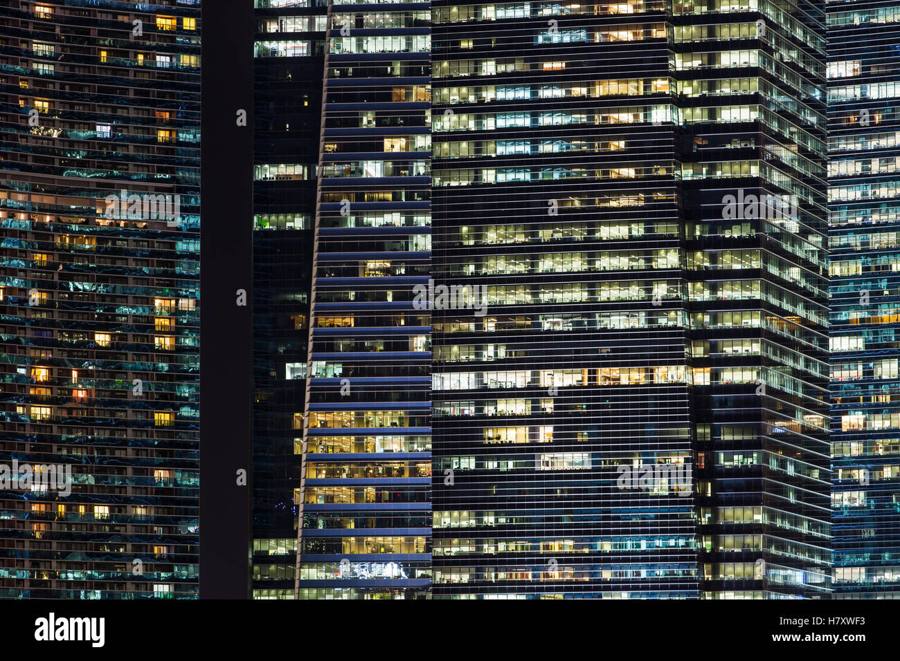 Office buildings at night in Singapore. Background with illuminated ...
