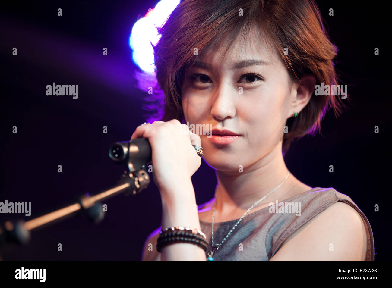 Young Chinese woman singing on stage Stock Photo - Alamy