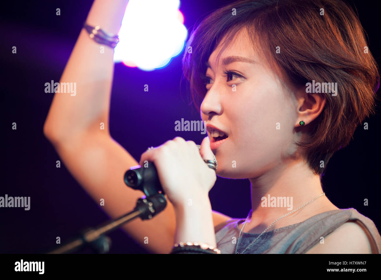 Young Chinese woman singing on stage Stock Photo - Alamy