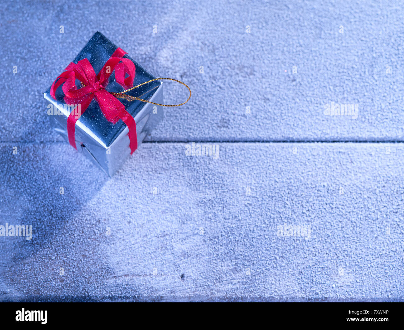 close up view of gift box on snowbound wooden back Stock Photo - Alamy