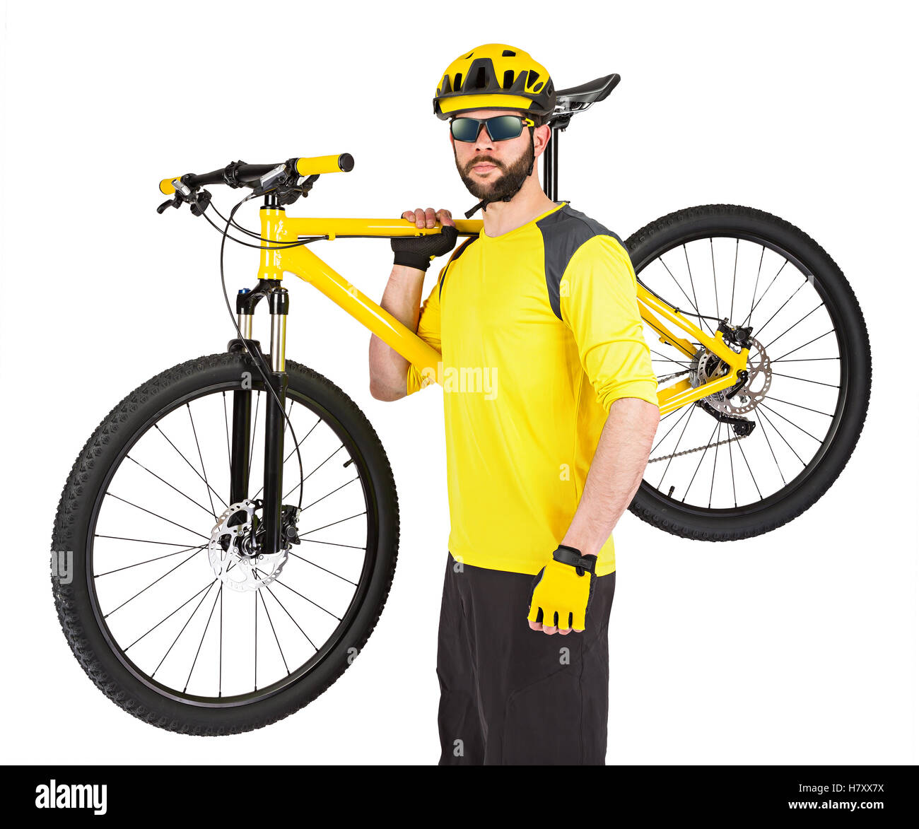 young cyclist with beard and yellow mountainbike on his shoulder ...