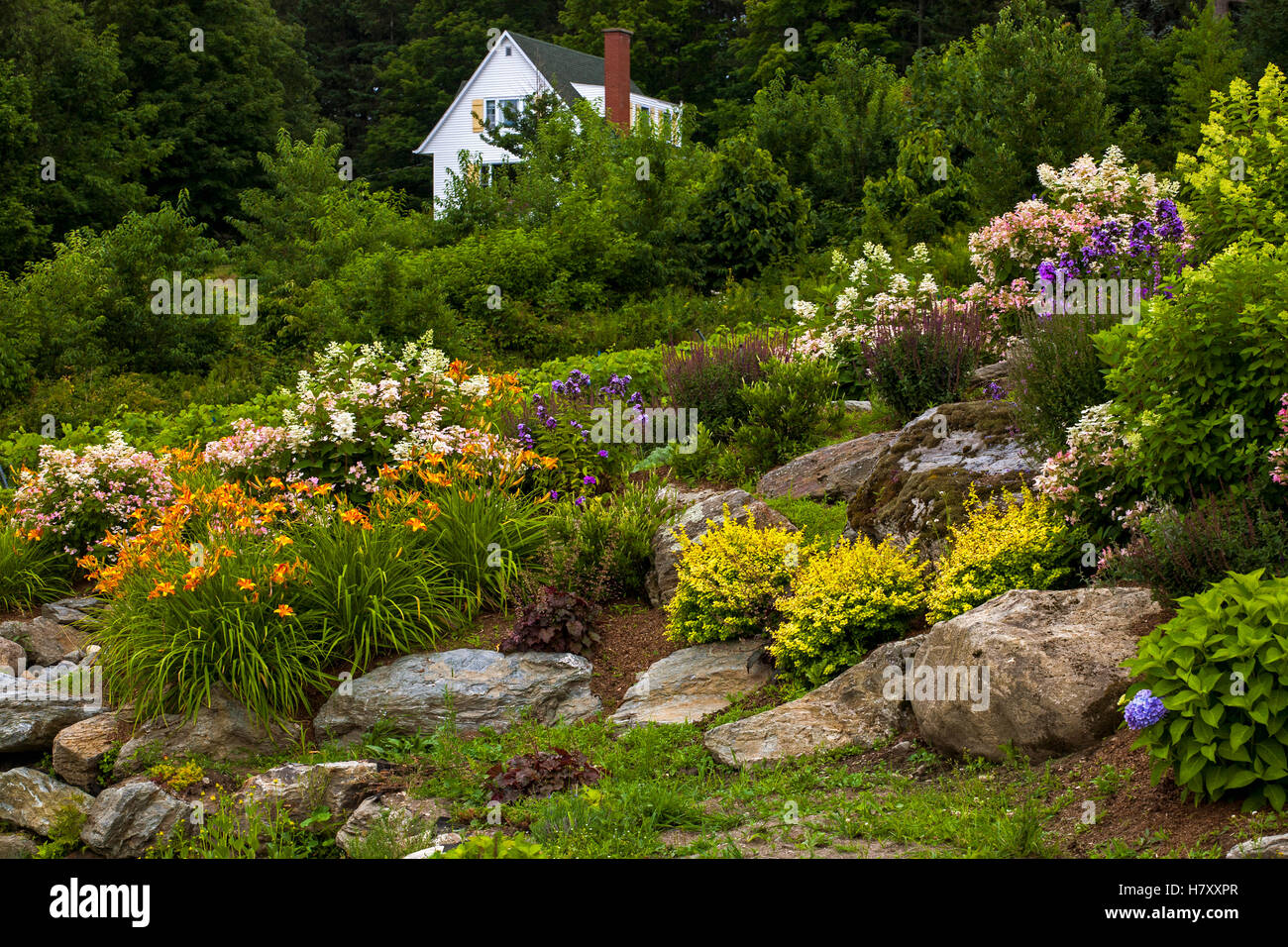 Rock garden and colourful blossoming plants; Knowlton, Quebec, Canada ...