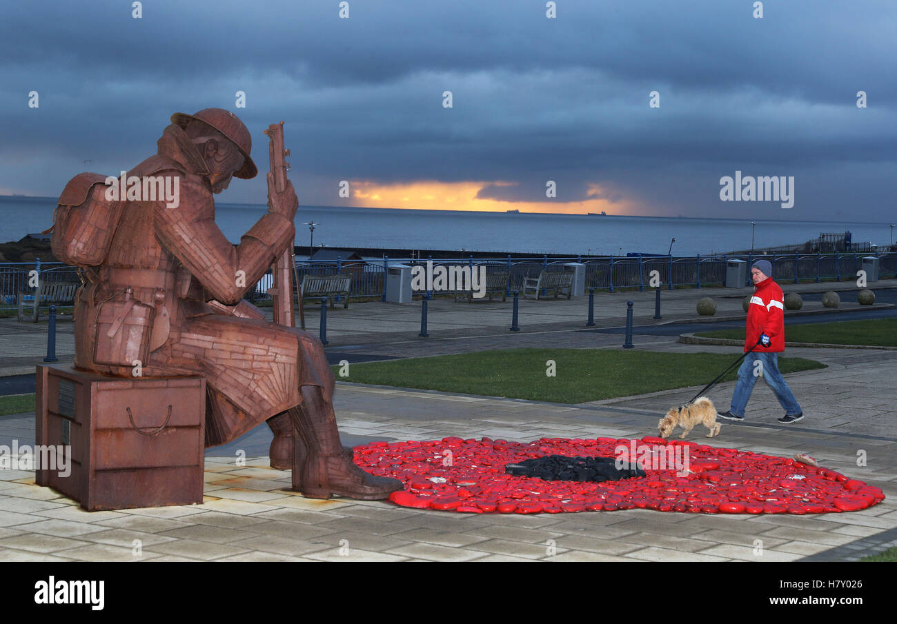 Hundreds of hand-painted pebbles have been placed at the foot of the ...