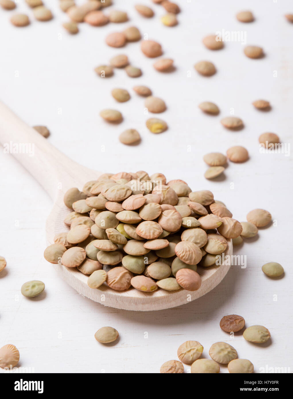 natural organic dry lentils on white table with wooden spoon Stock ...