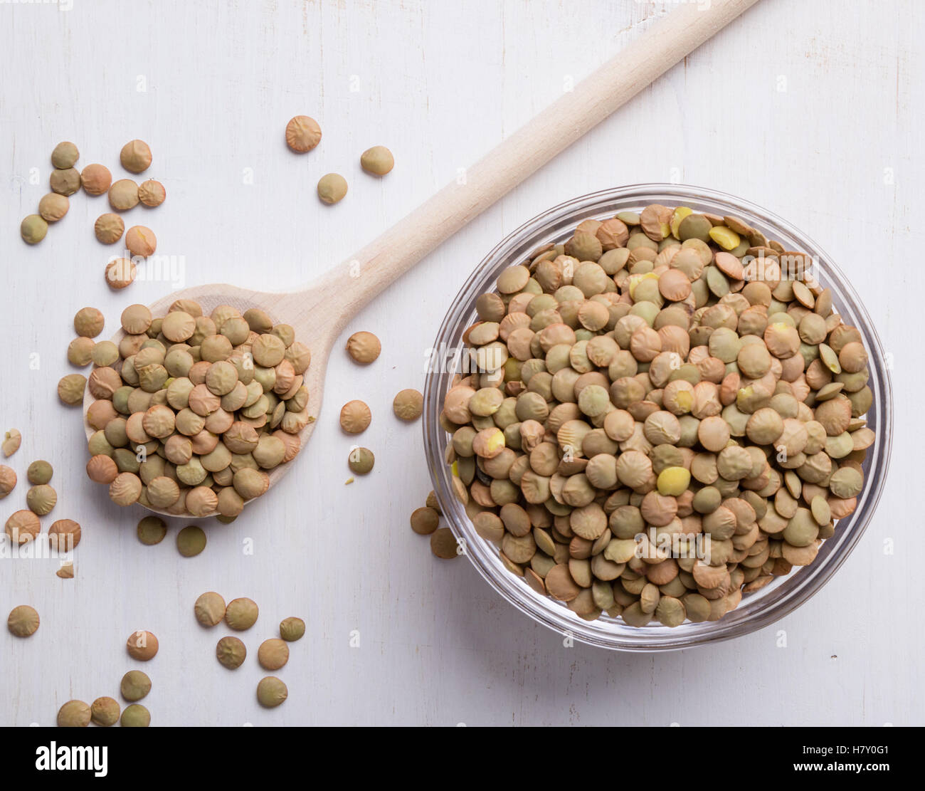 natural organic dry lentils on white table with wooden spoon Stock ...