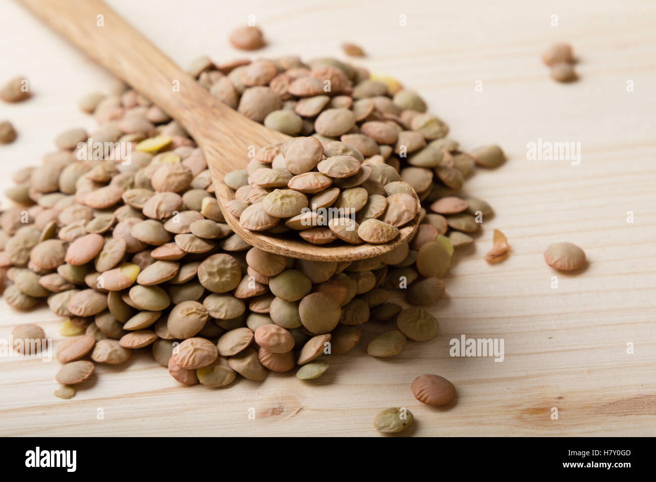 natural organic dry lentils on wooden table with spoon Stock Photo - Alamy