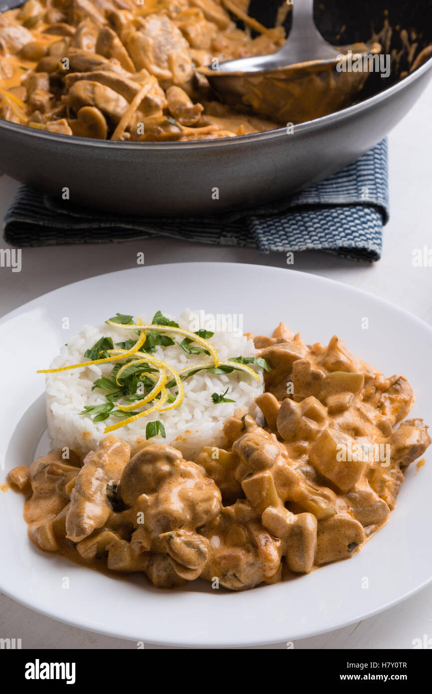 beef stroganoff with rice on white plate Stock Photo - Alamy