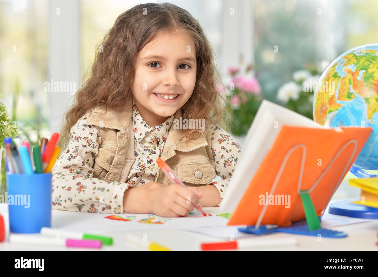 Little girl drawing at class Stock Photo - Alamy