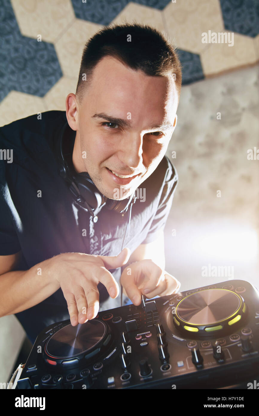 Young man DJ with mixer is working Stock Photo - Alamy