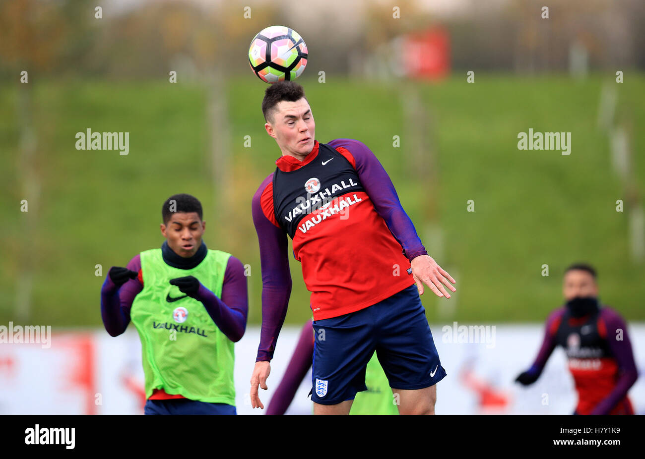 England's Michael Keane heads the ball during a training session at St ...