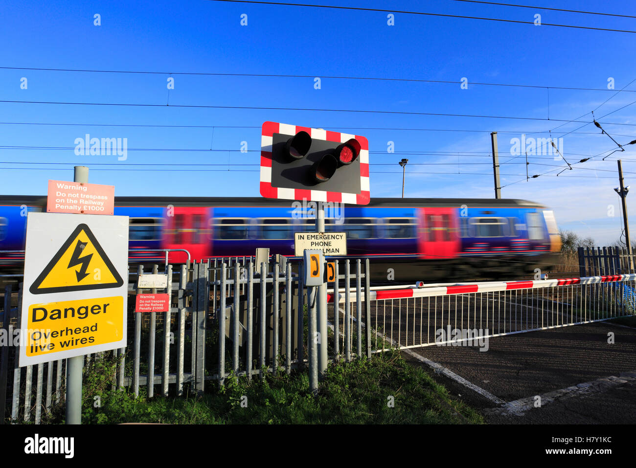 Speeding train passing an unmanned level crossing, East Coast Main Line ...
