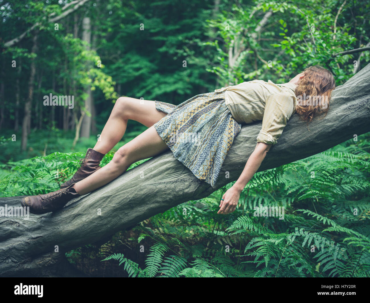 Young woman lying on tree High Resolution Stock Photography and Images ...