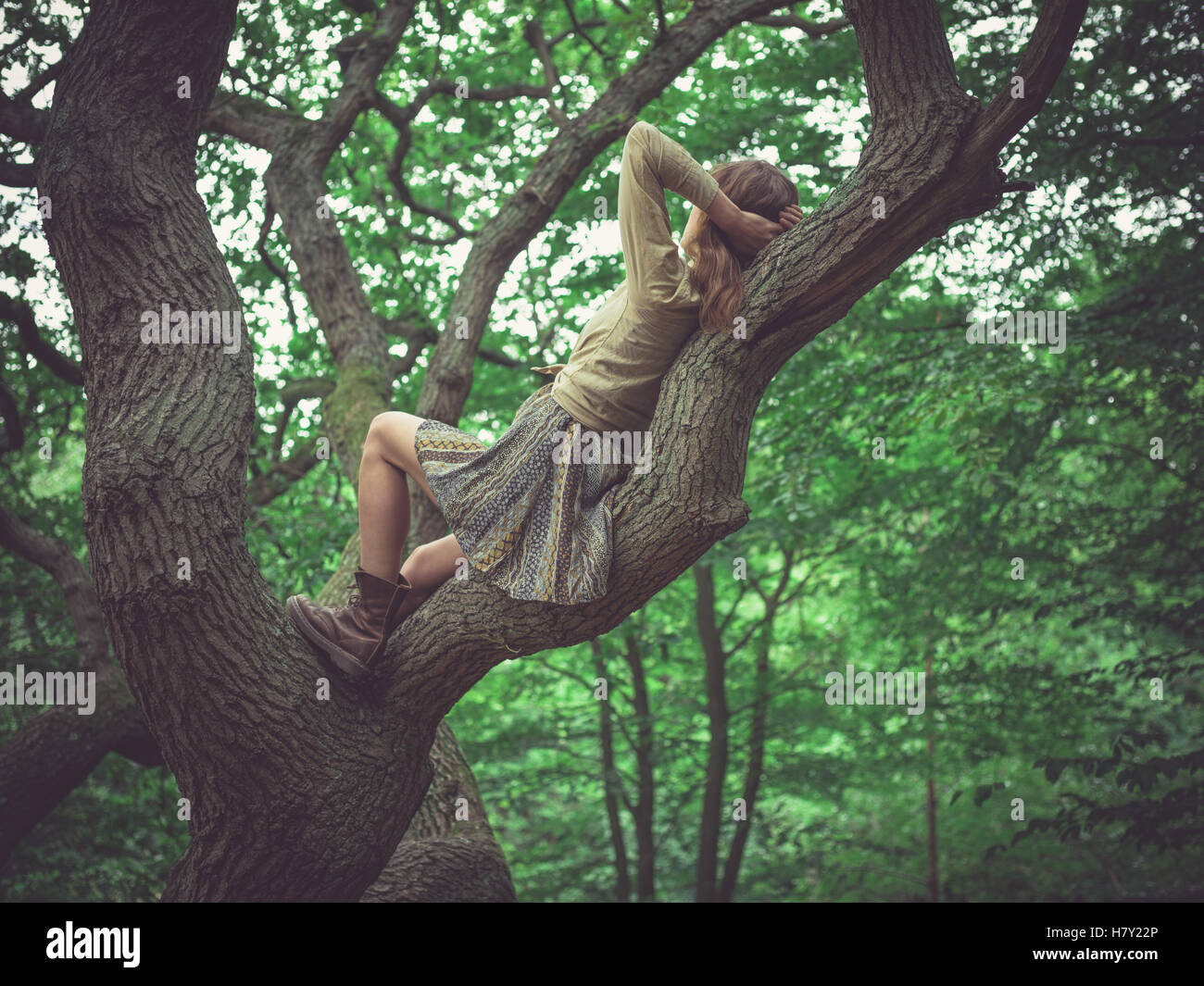Girl lying tree branch hi-res stock photography and images - Alamy