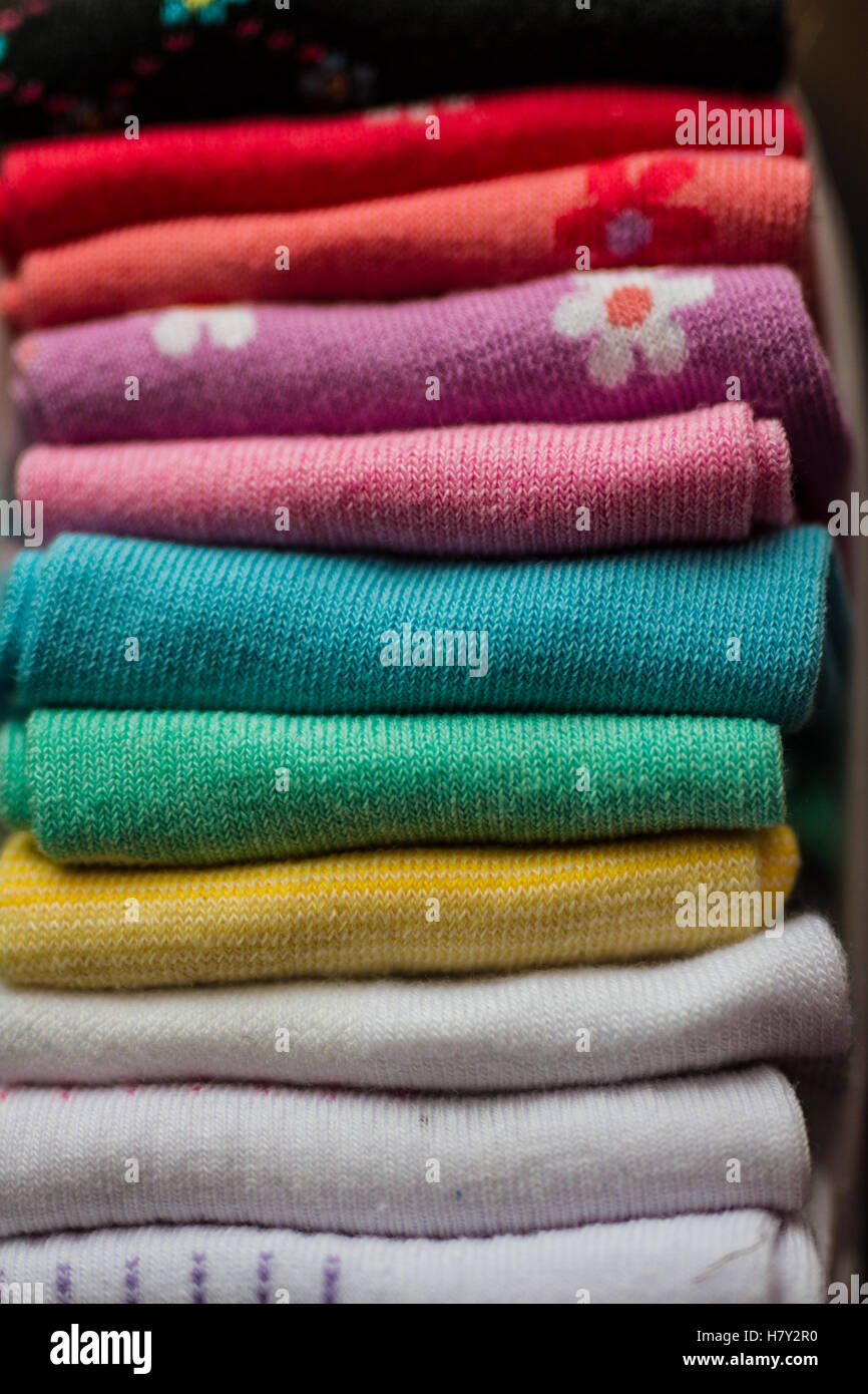 A pile of colorful clothes on white Stock Photo - Alamy