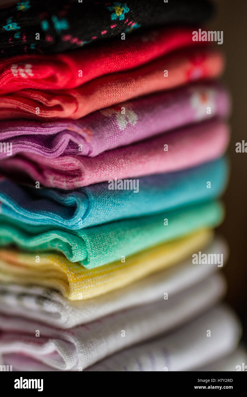 A pile of colorful clothes on white Stock Photo - Alamy