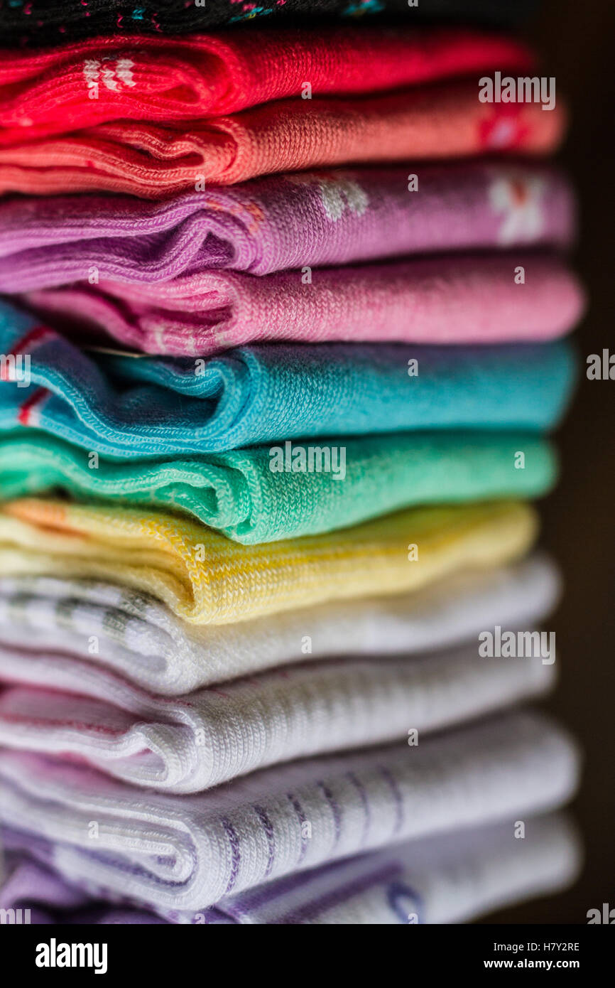 A pile of colorful clothes on white Stock Photo - Alamy