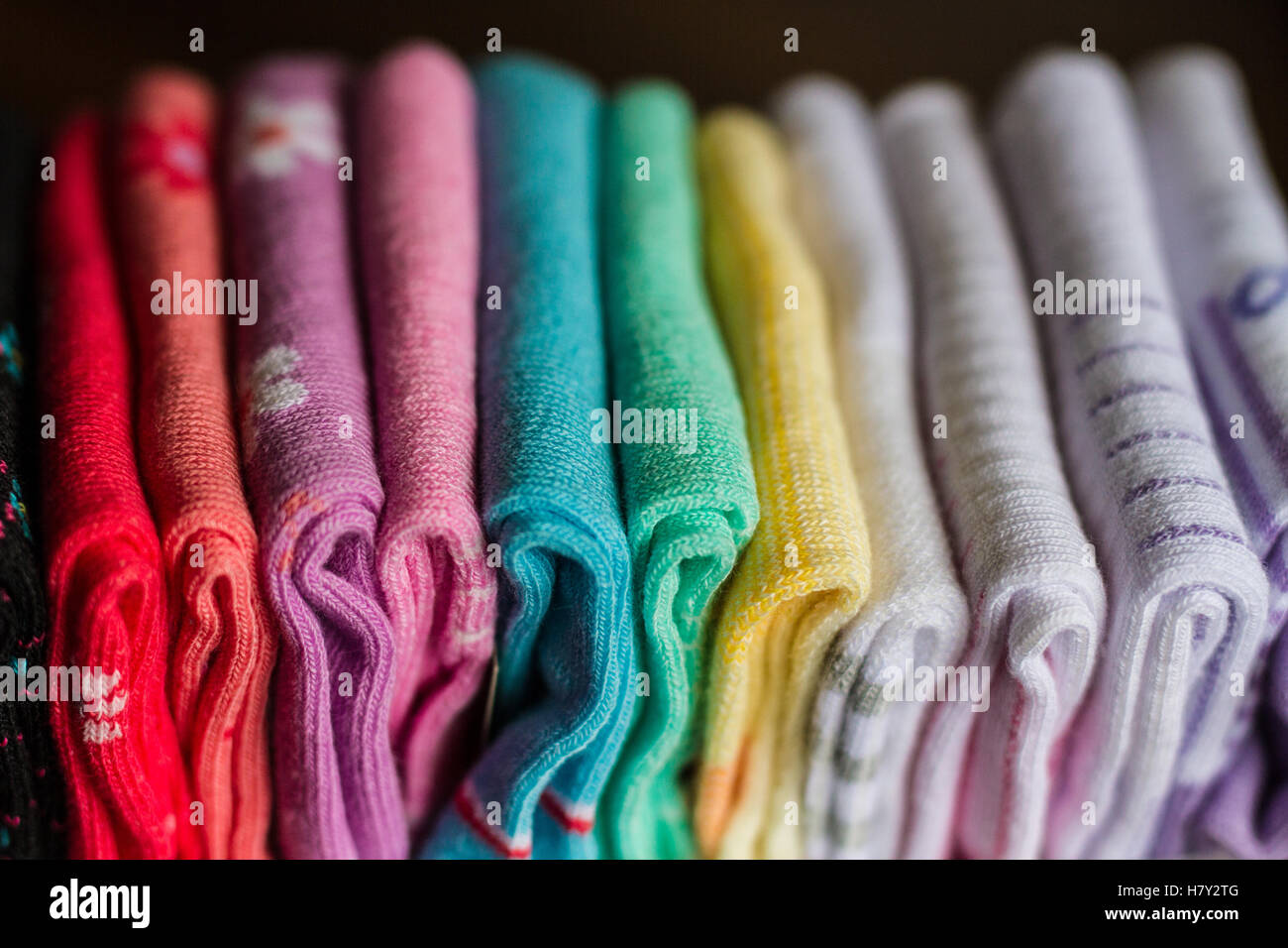 A pile of colorful clothes on white Stock Photo - Alamy