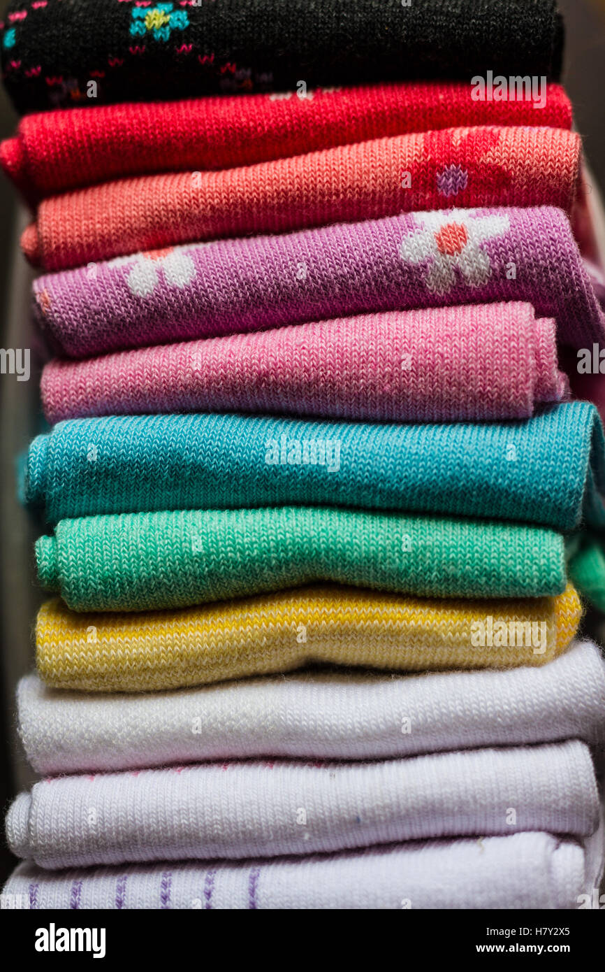 A pile of colorful clothes on white Stock Photo - Alamy