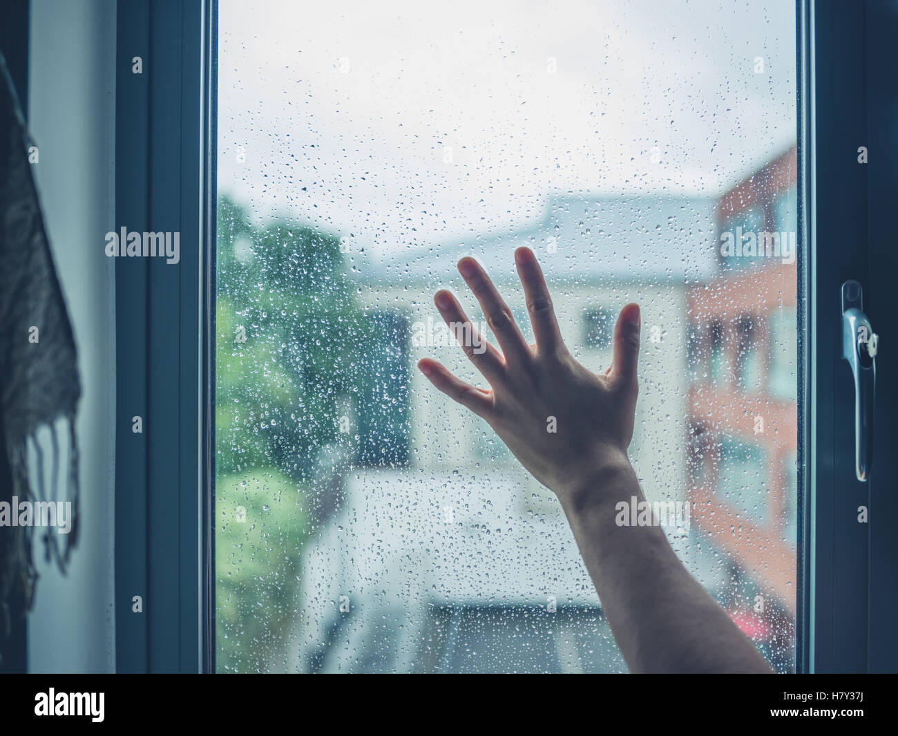 A youg man's hand is wiping the dew from a window Stock Photo - Alamy