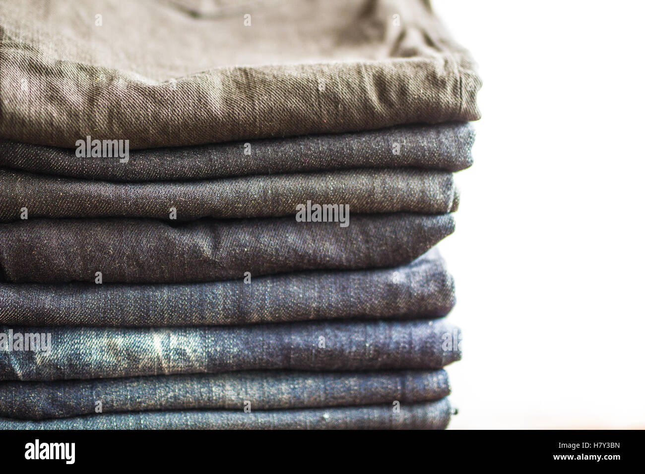 Stack of jeans on white background Stock Photo - Alamy